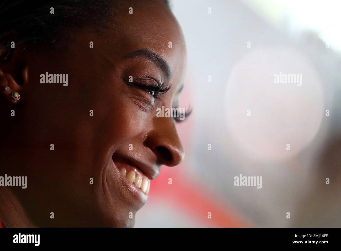 Simone Biles of the U.S. smiles as she arrives for a news conference ...