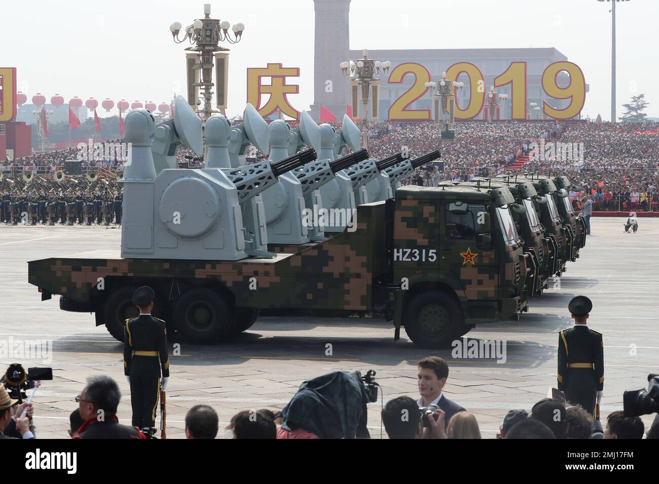 Military vehicles roll down as members of a Chinese military honor ...