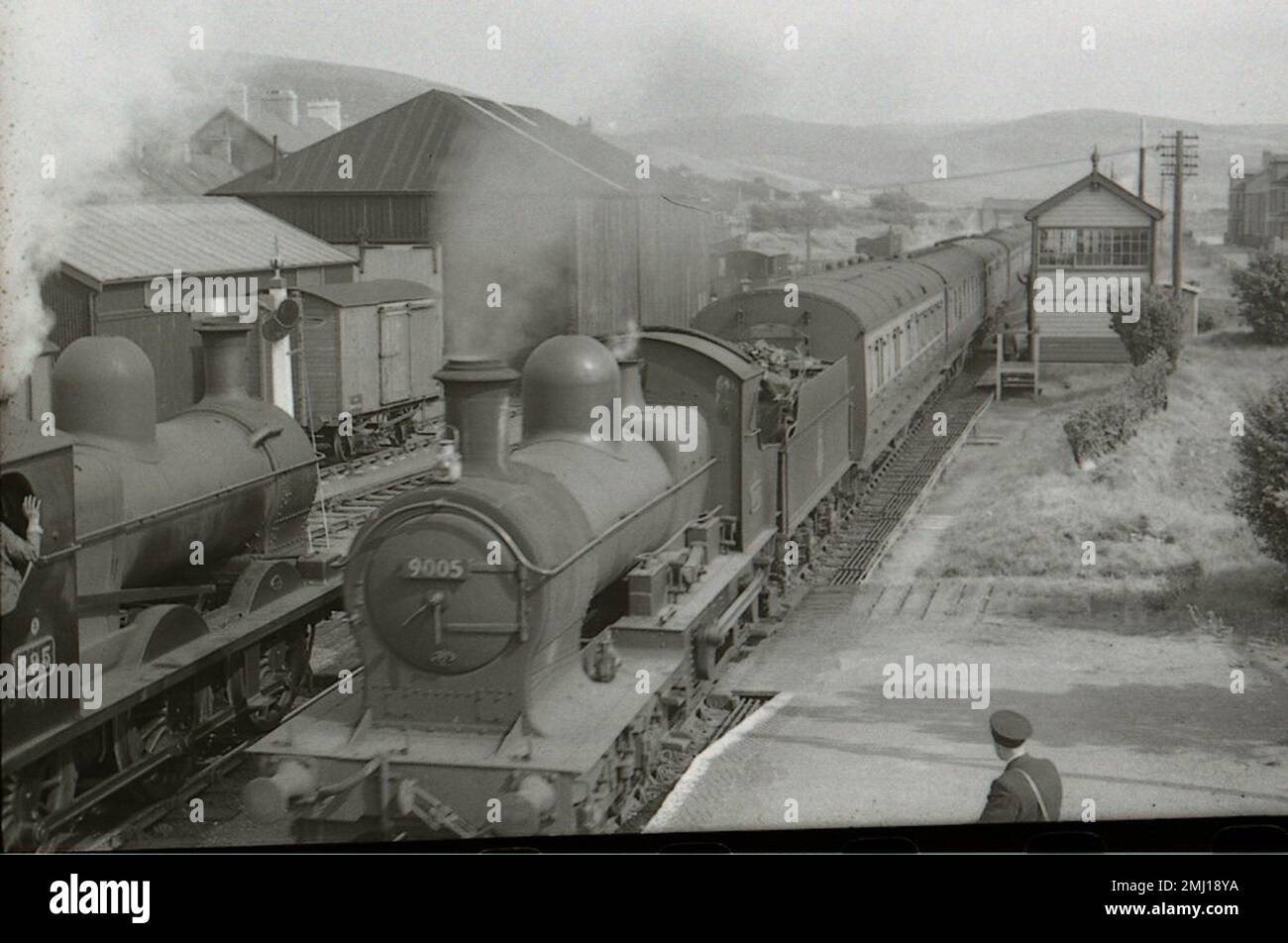 A GWR 'Dukedog' 4-4-0 No. 9005 with a down stopping train crossing at ...