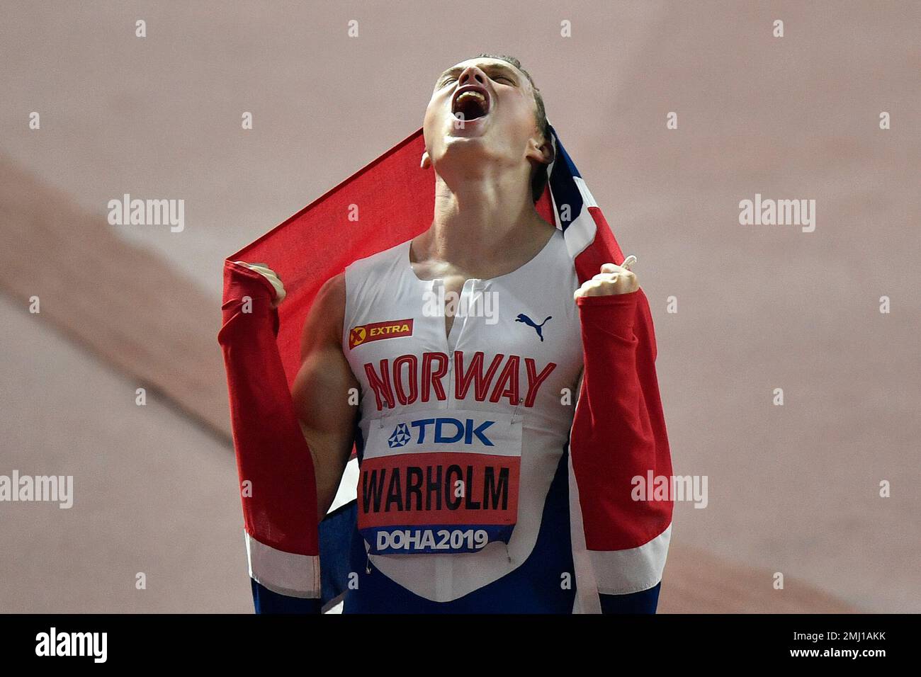 Karsten Warholm, of Norway, celebrates after winning the gold medal in ...