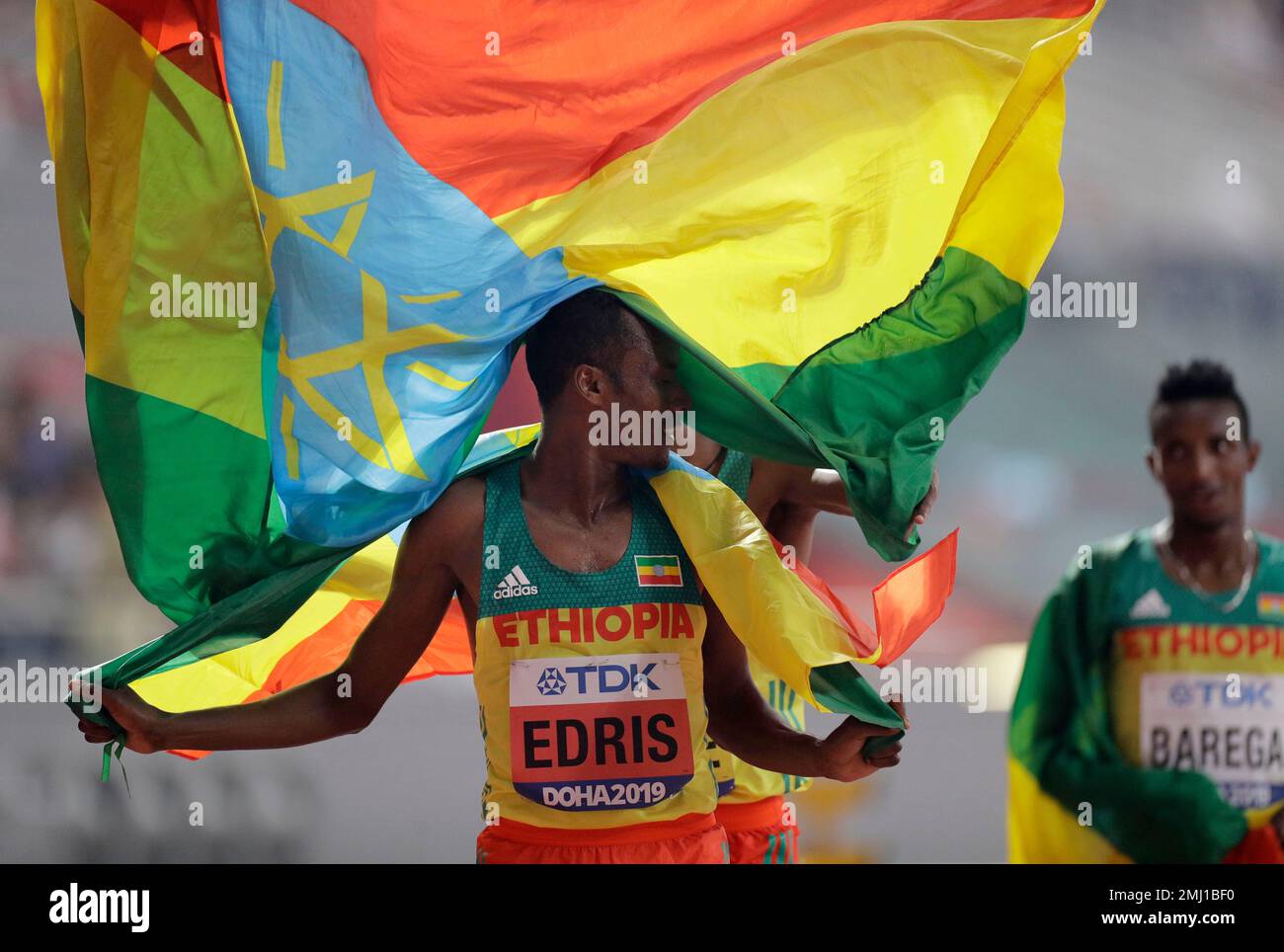 Muktar Edris, of Ethiopia celebrates after winning the gold medal in ...