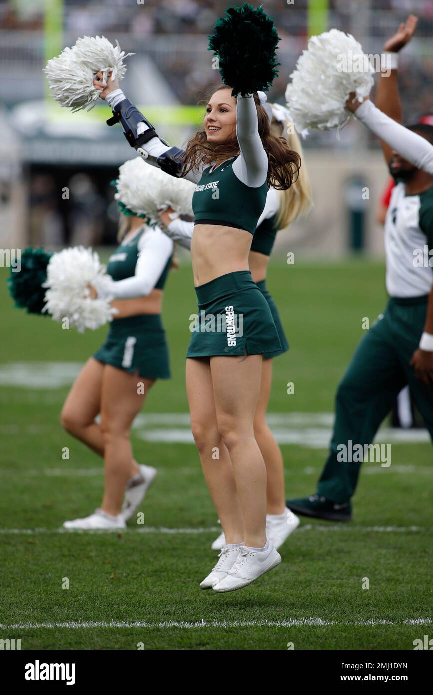 Michigan State cheerleaders perform during an NCAA college football ...