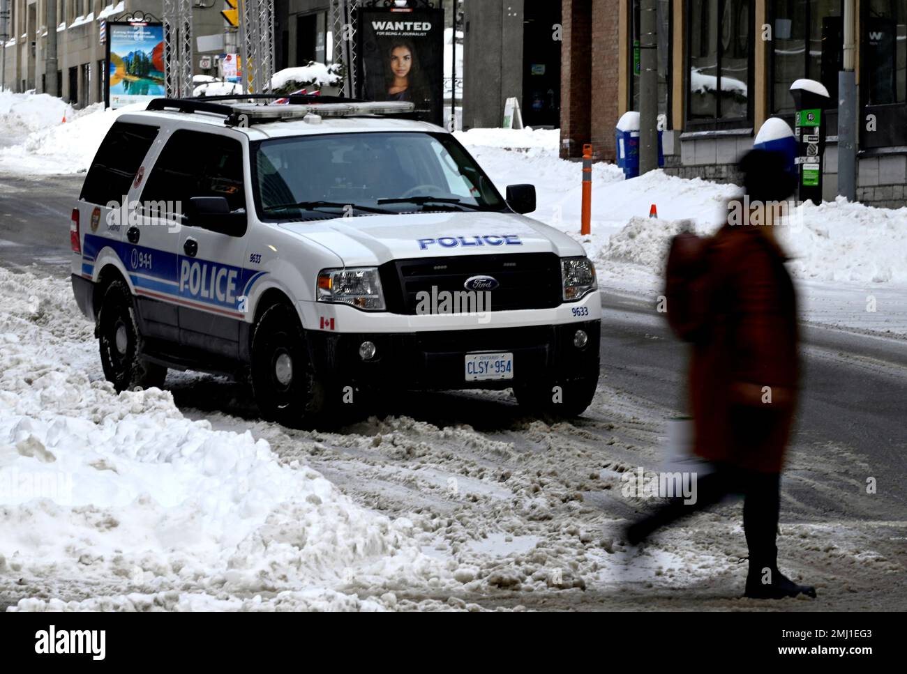 An Ottawa Police officer sits in their cruiser on O'Connor Street below ...