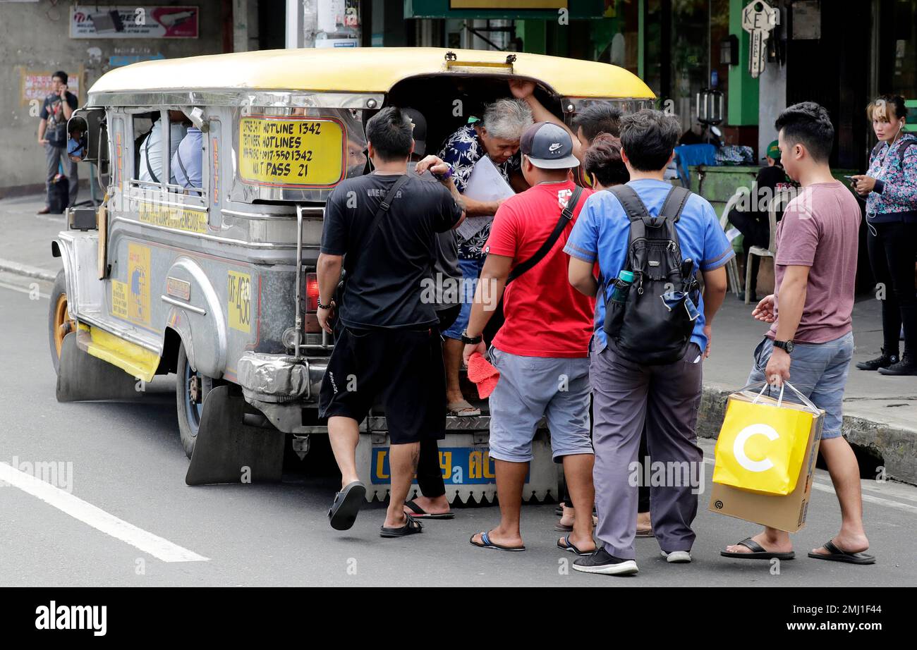 Commuters rush to board a passenger "jeepney" during a transport strike ...