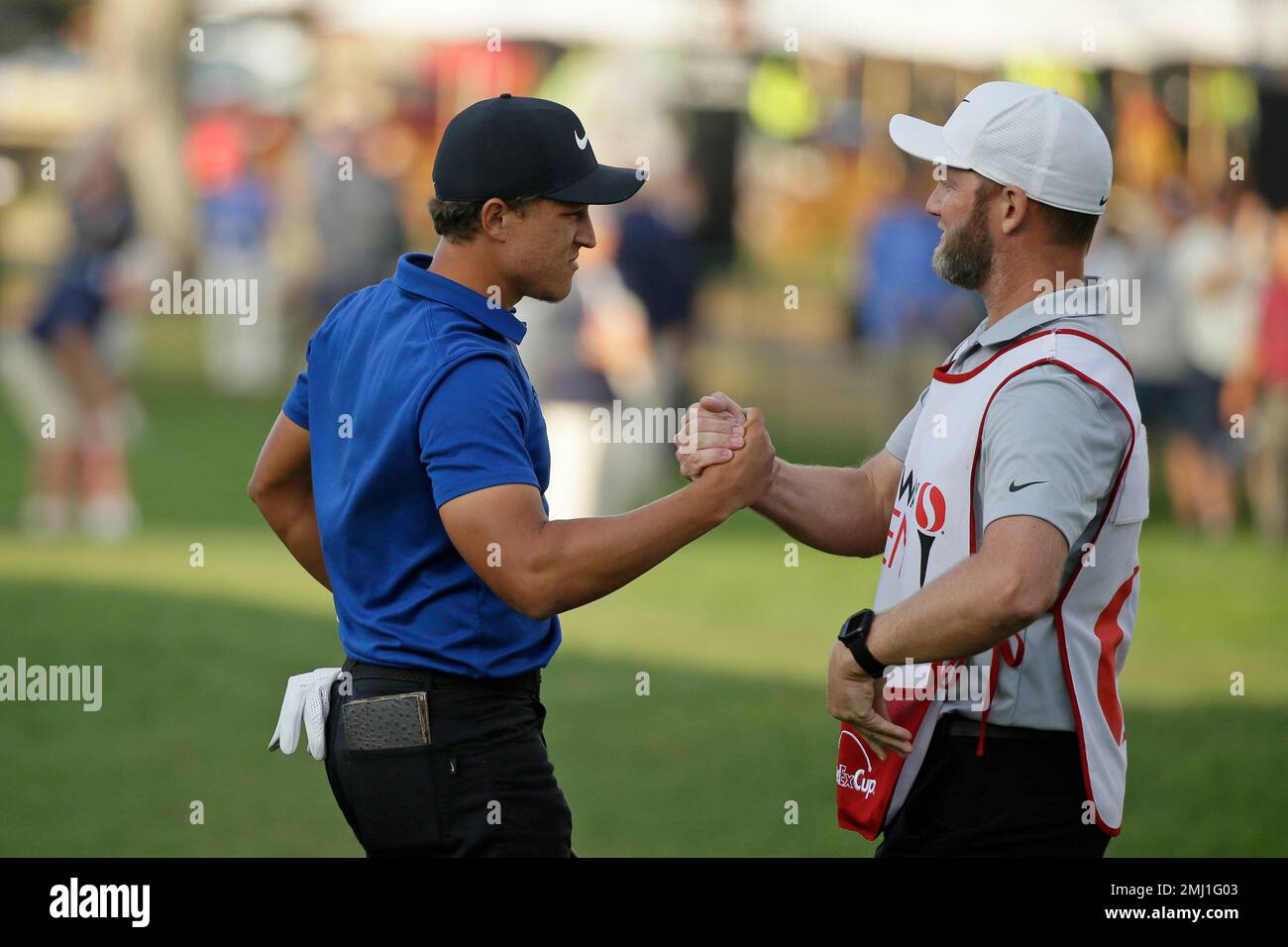Cameron Champ is greeted by his caddie, Kurtis Kowaluk on the 18th ...