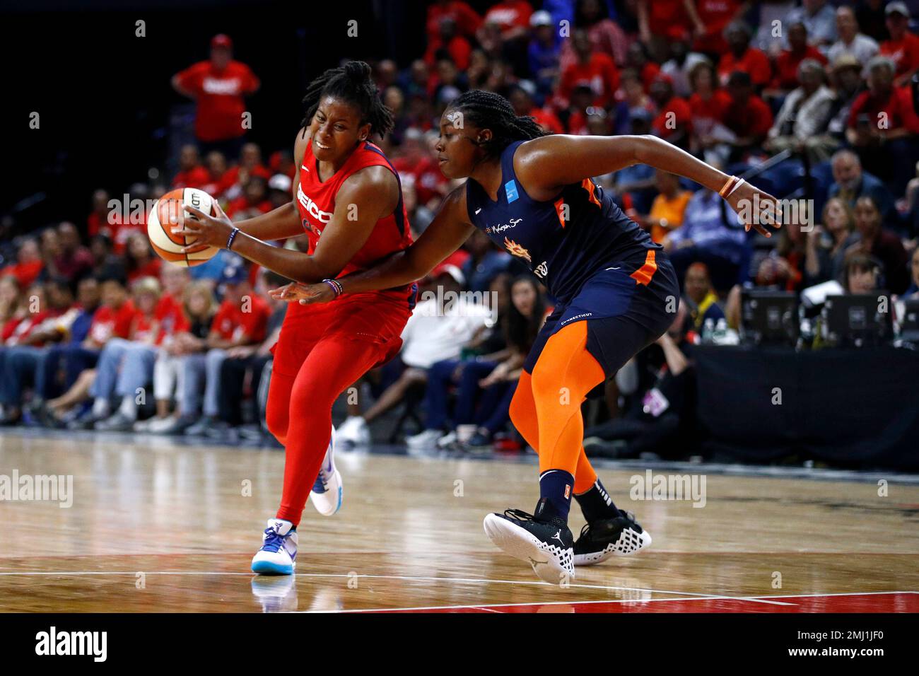 Washington Mystics guard Ariel Atkins, left, drives against Connecticut ...