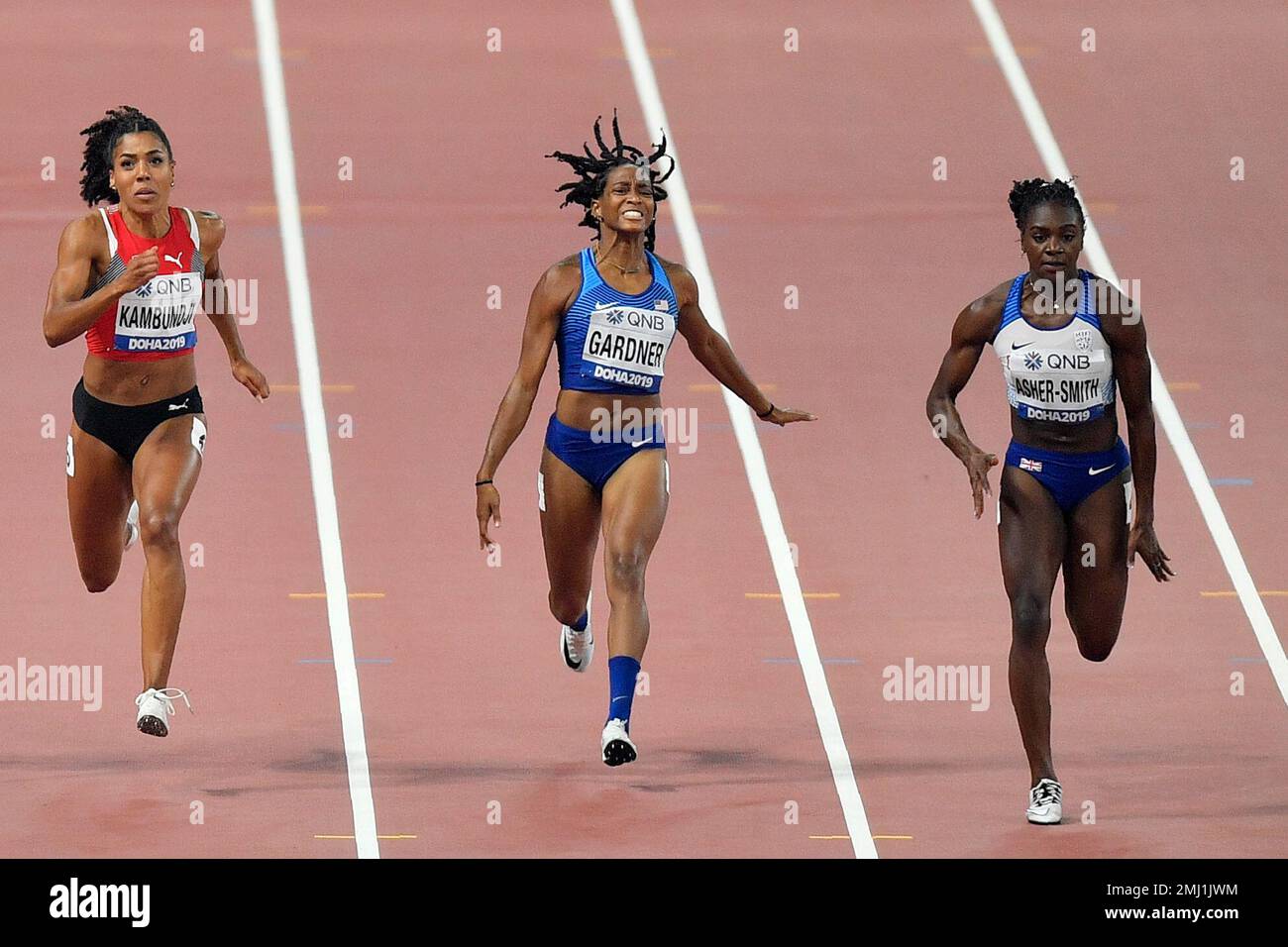 English Gardner, of the United States, center, grimaces while running ...