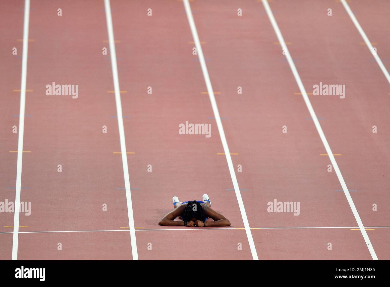 English Gardner, of the United States, lays on the track after failing ...