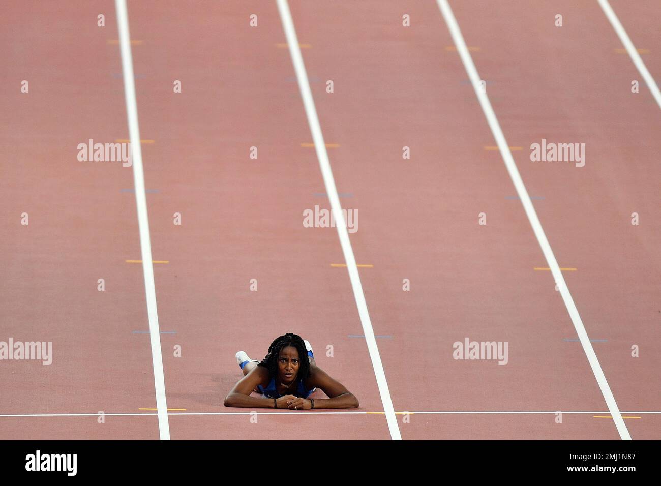 English Gardner, of the United States, lays on the track after failing ...