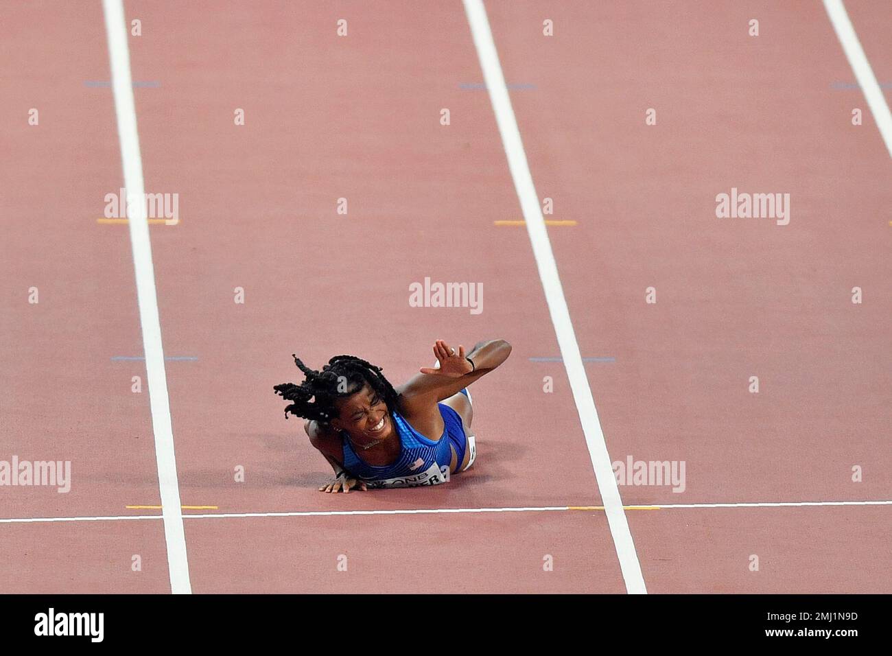 English Gardner, of the United States, lays on the track after failing ...
