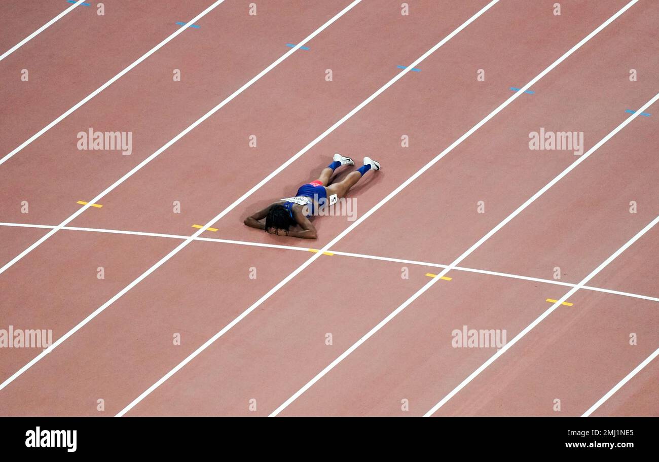 English Gardner, of the United States, lays on the track after failing ...