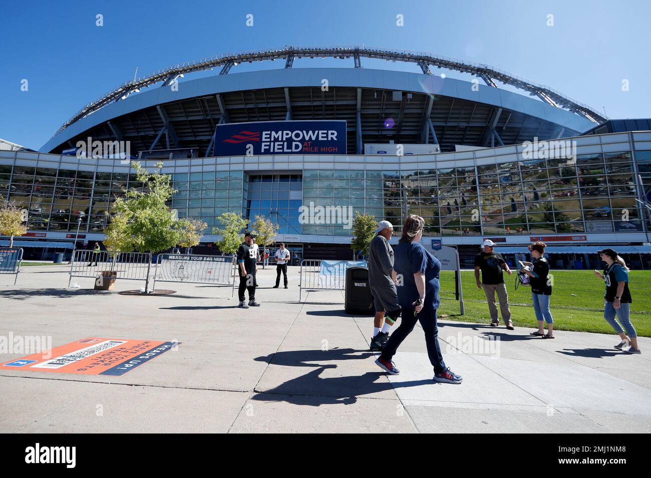 Denver Broncos fans walk in front of Empower Field before an NFL ...