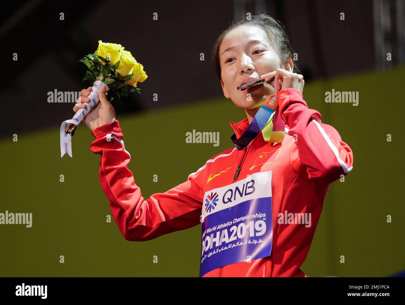 Rui Liang of China, gold winner, bites her medal during the medal ...
