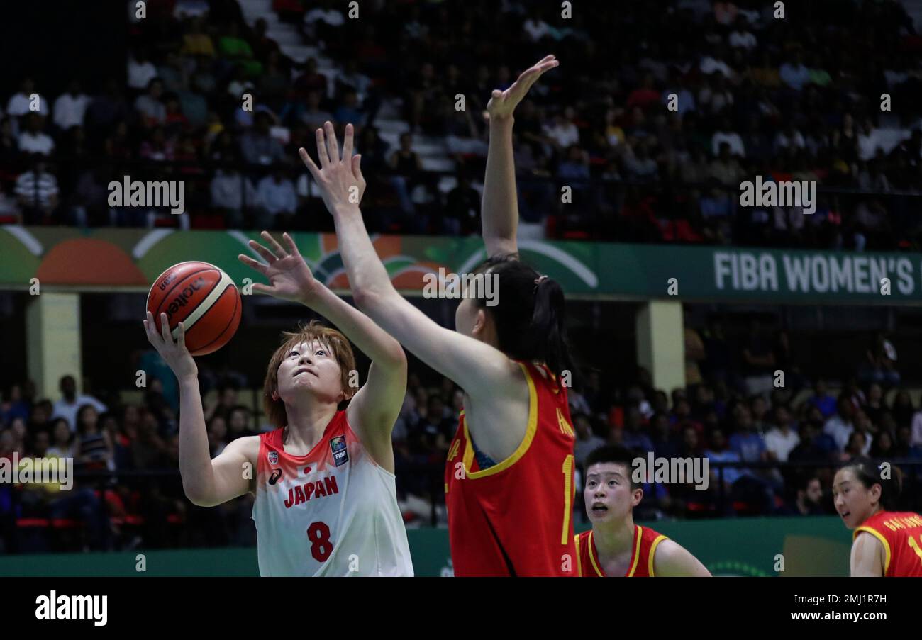 Japan's Maki Takada, left, leaps to score past China's Xu Han during ...