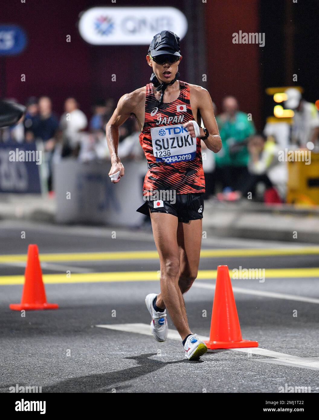 Japan's Yusuke Suzuki walks to winning the men's 50 kilometer race walk ...