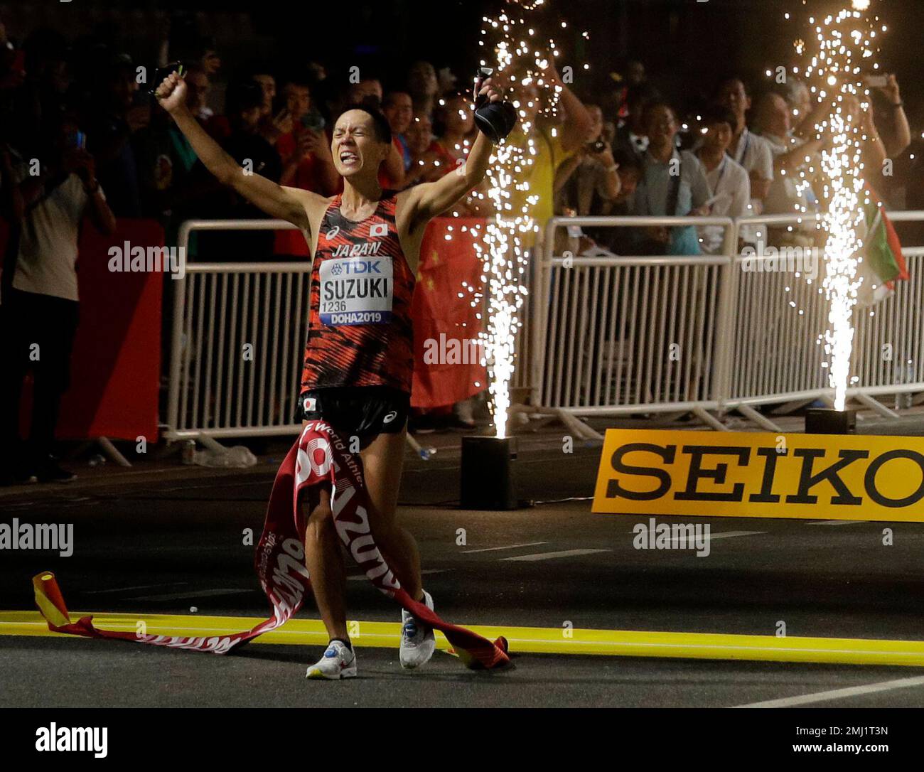 Japan's Yusuke Suzuki celebrates after winning the men's 50 kilometer ...