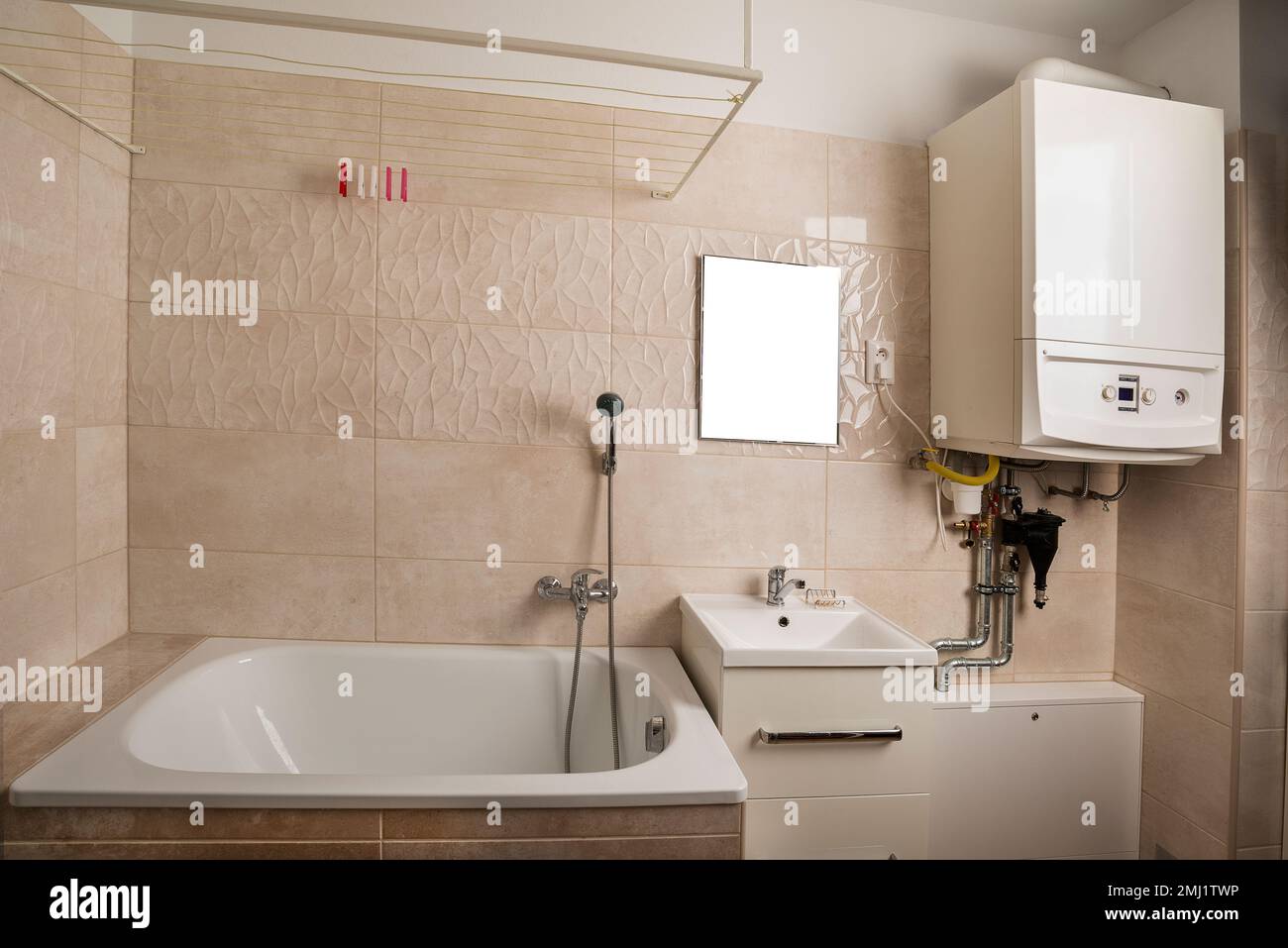 Bathroom with a condensate gas boiler bathtub and wash basin Stock ...