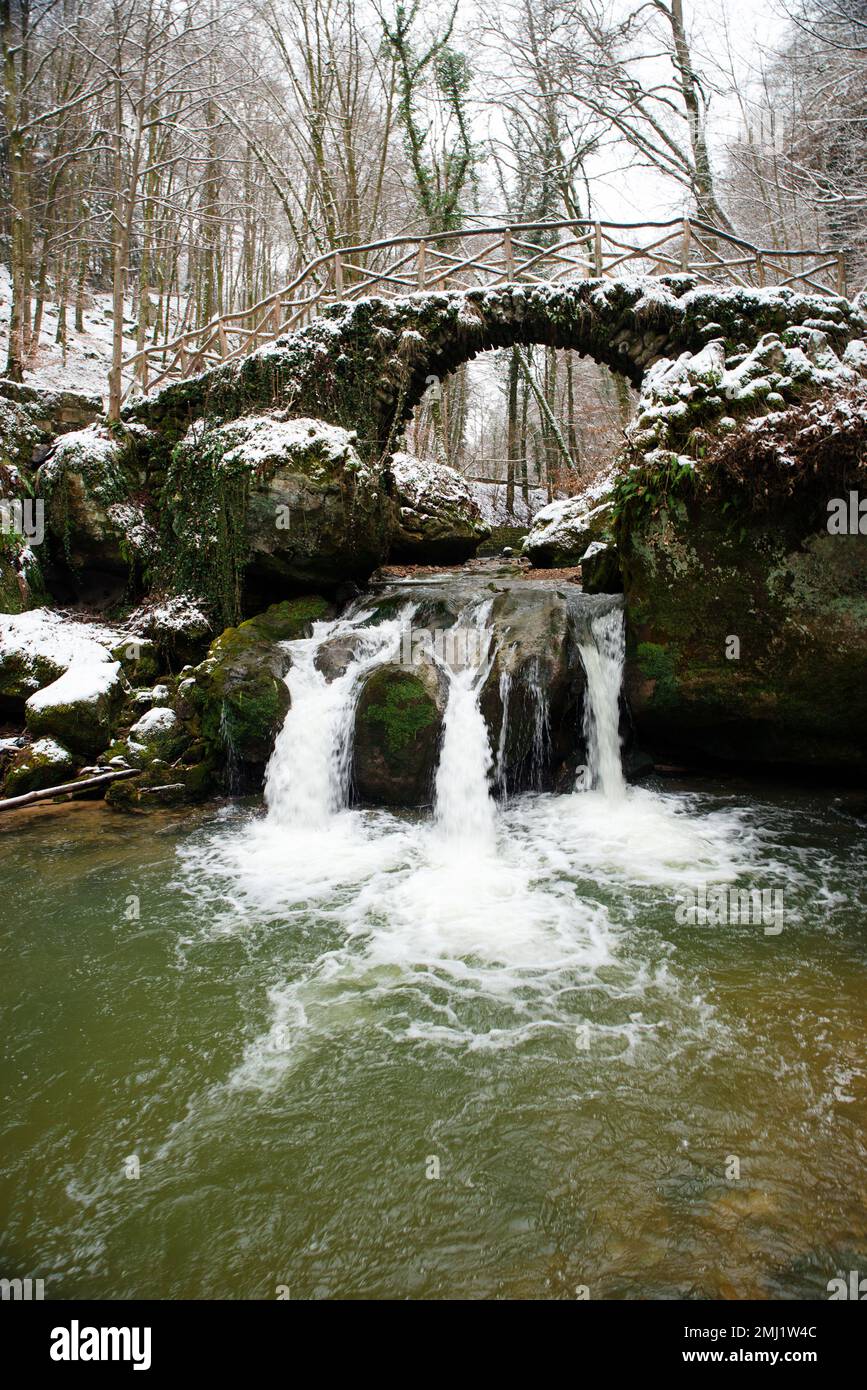 Scheissendempel waterfall, river Black Ernz with stone bridge covered ...
