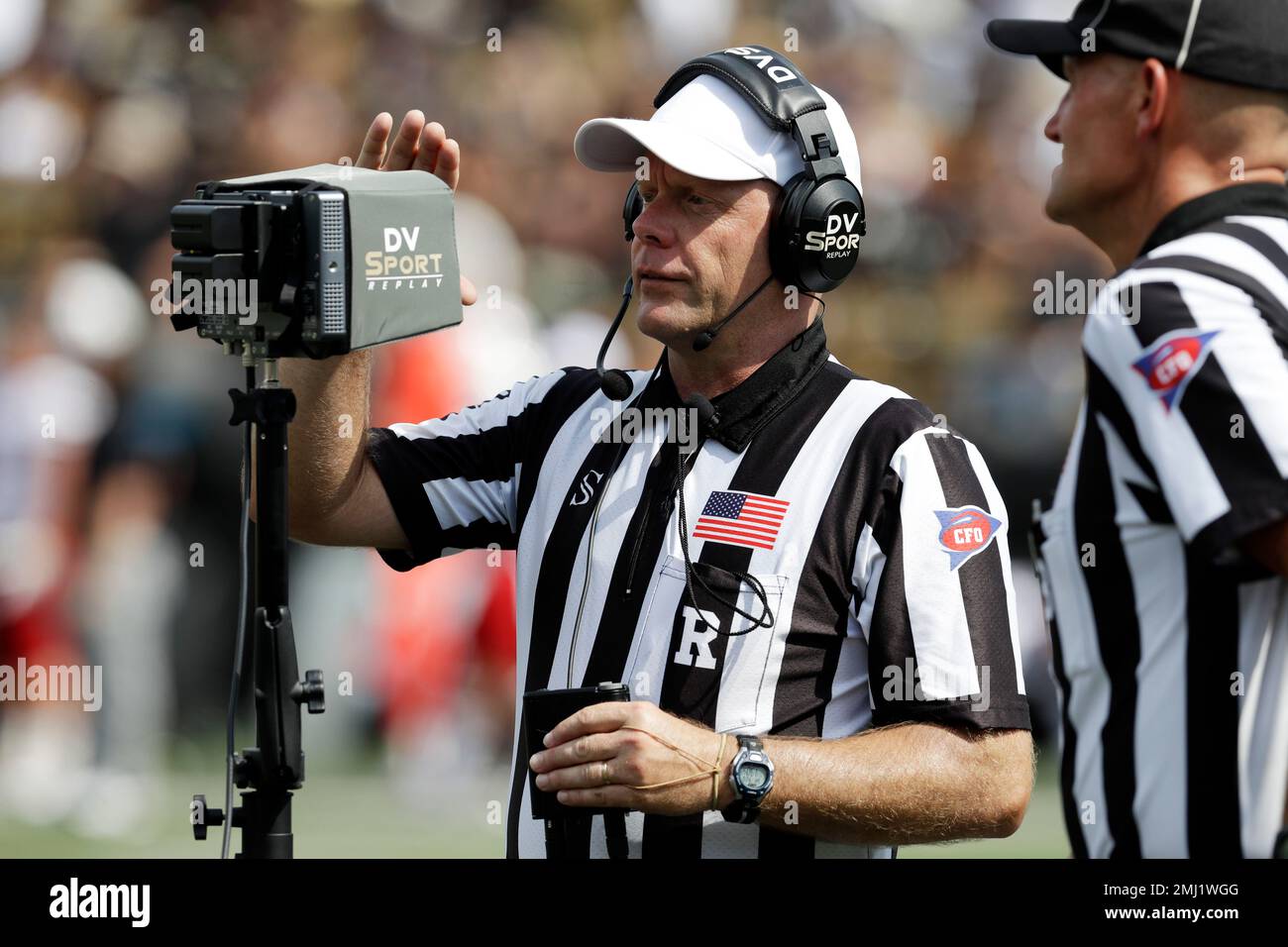 Referee Greg Blum watches a replay in the second half of an NCAA college football game between ...