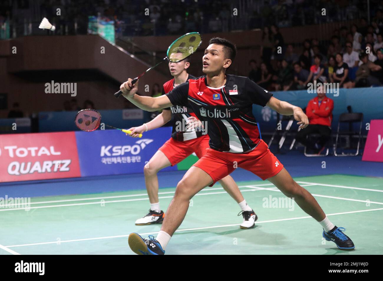 Indonesia's Muhammad Rian Ardianto, right, returns a shot as his ...