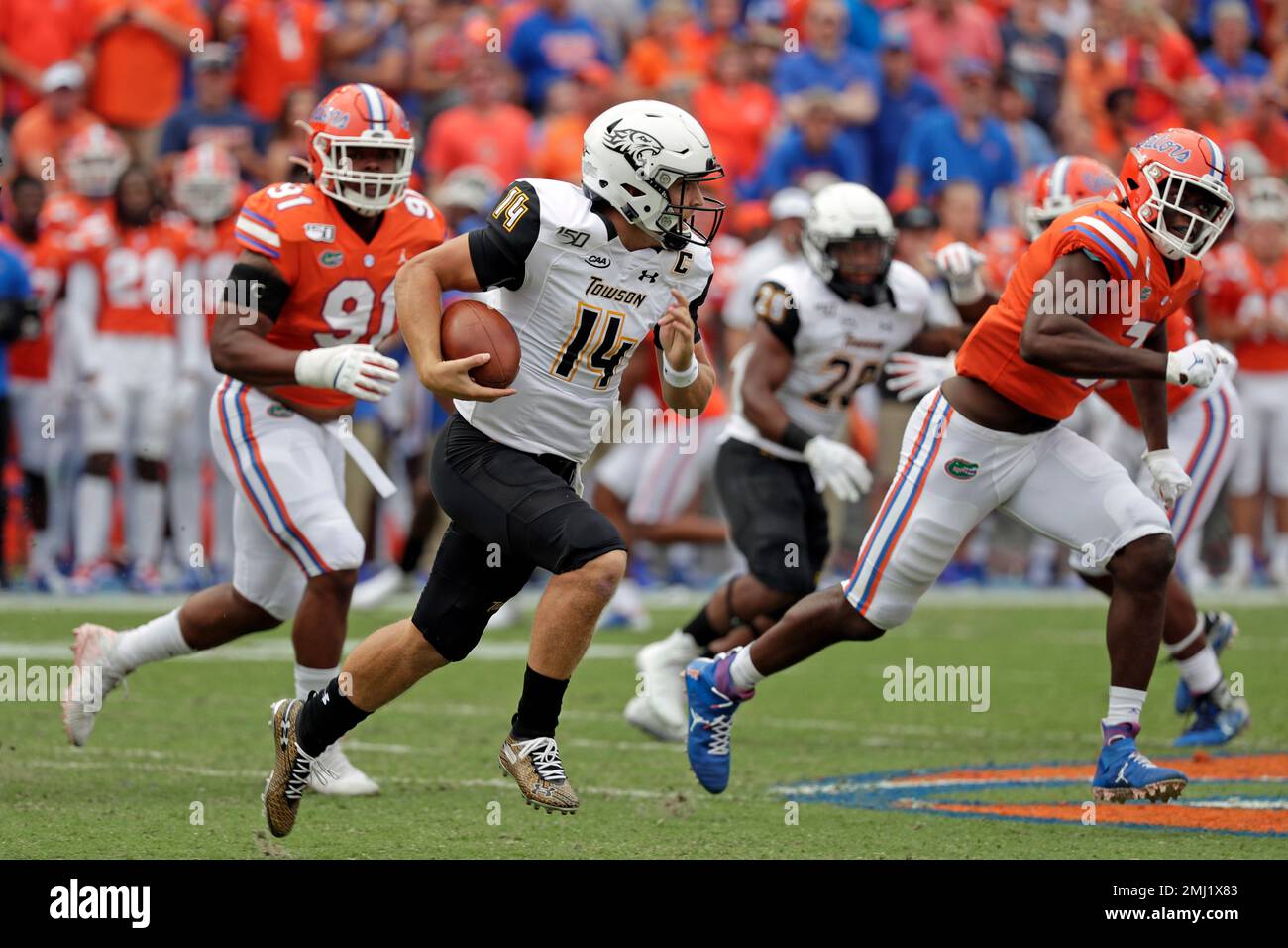 Towson quarterback Tom Flacco (14) scrambles away from Florida ...