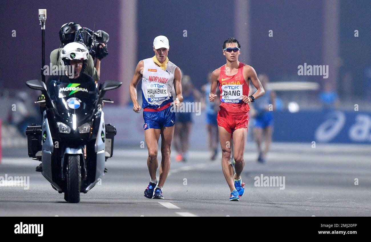 Norway's Havard Haukenes, left, and China's Qin Wang compete in the the ...