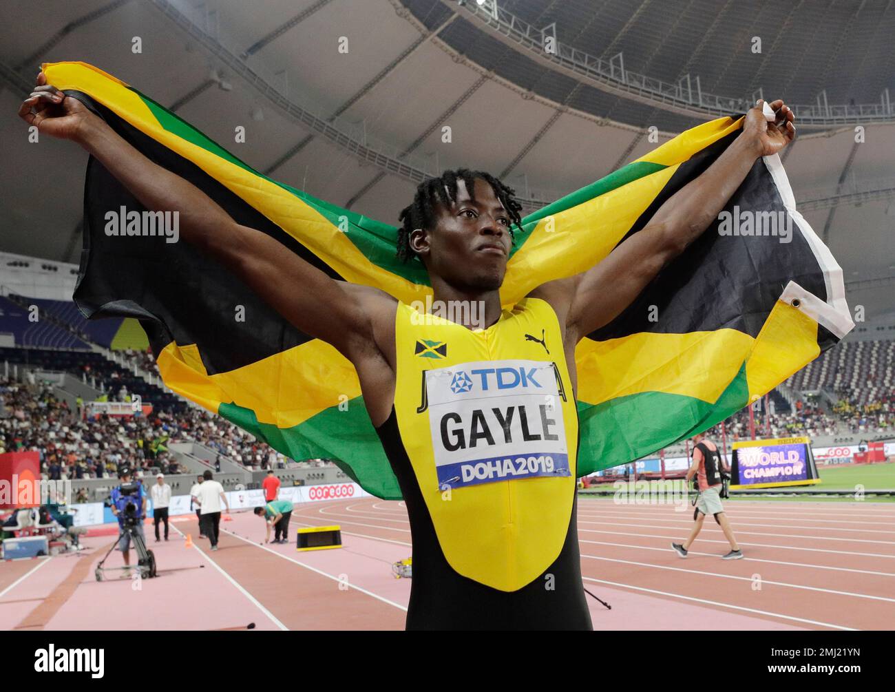 Tajay Gayle, of Jamaica, celebrates winning the gold medal for men's ...