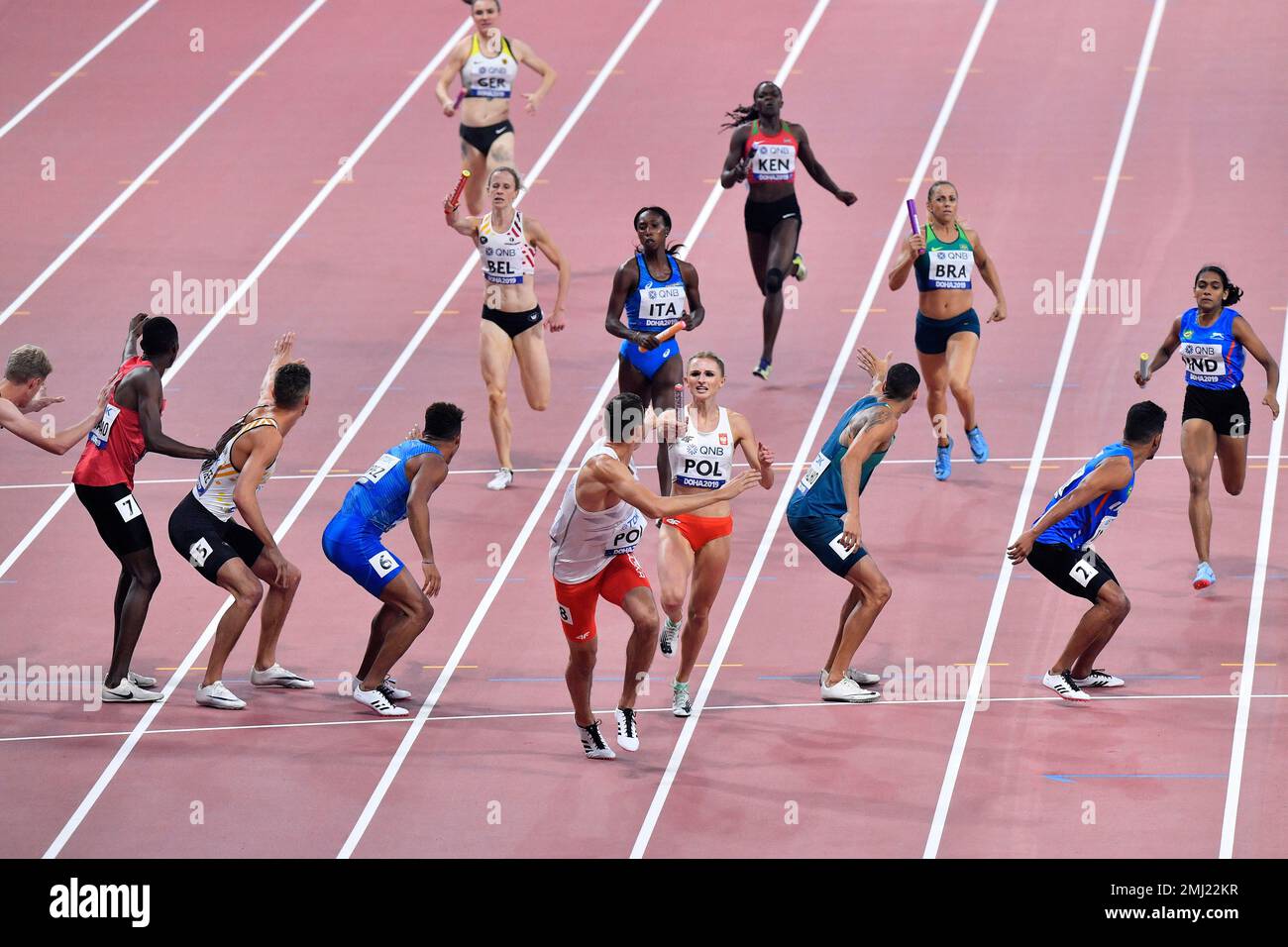 Athletes compete in a mixed 4 x 400 meter relay race heat during the ...