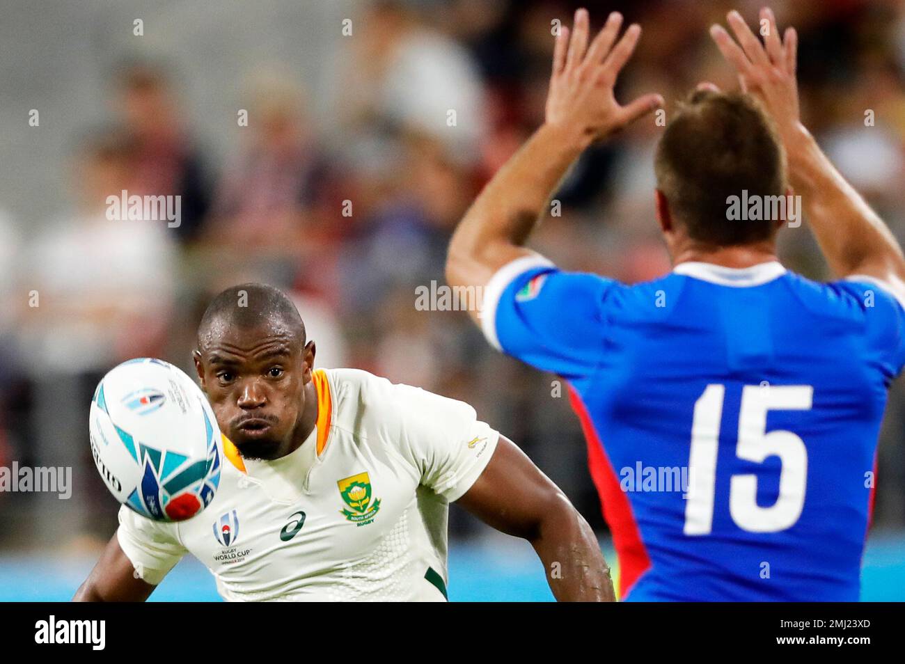 South Africa's Makazole Mapimpi, left, eyes the ball past Namibia's ...