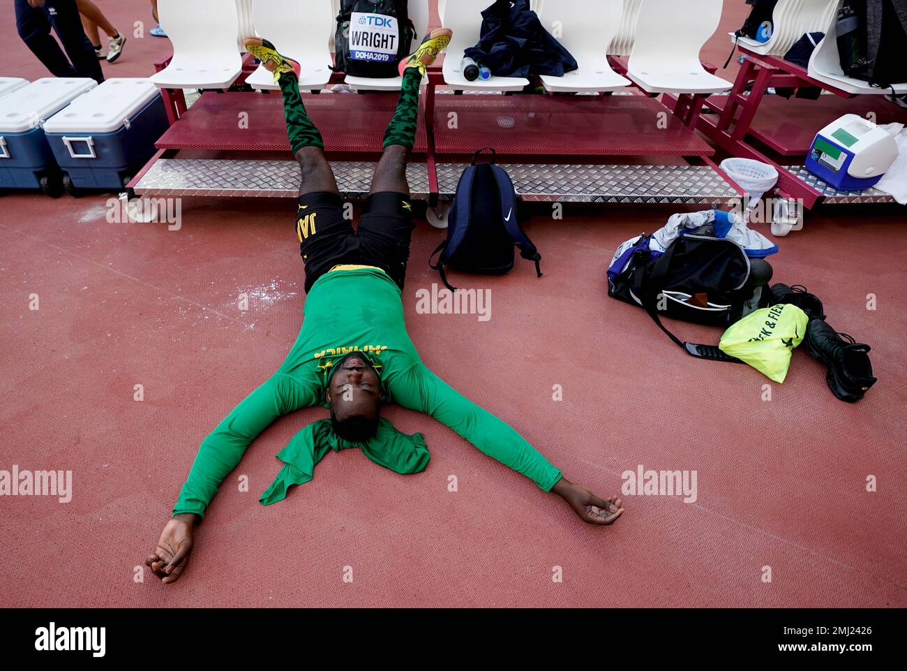 Chad Wright, of Jamaica, stretches before the the men's discus throw at ...