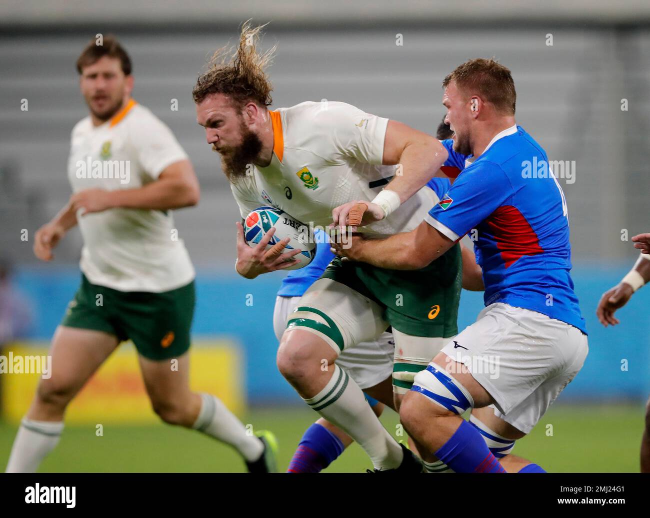 South Africa's RG Snyman, centre, runs at Namibia's Johan Retief, right ...
