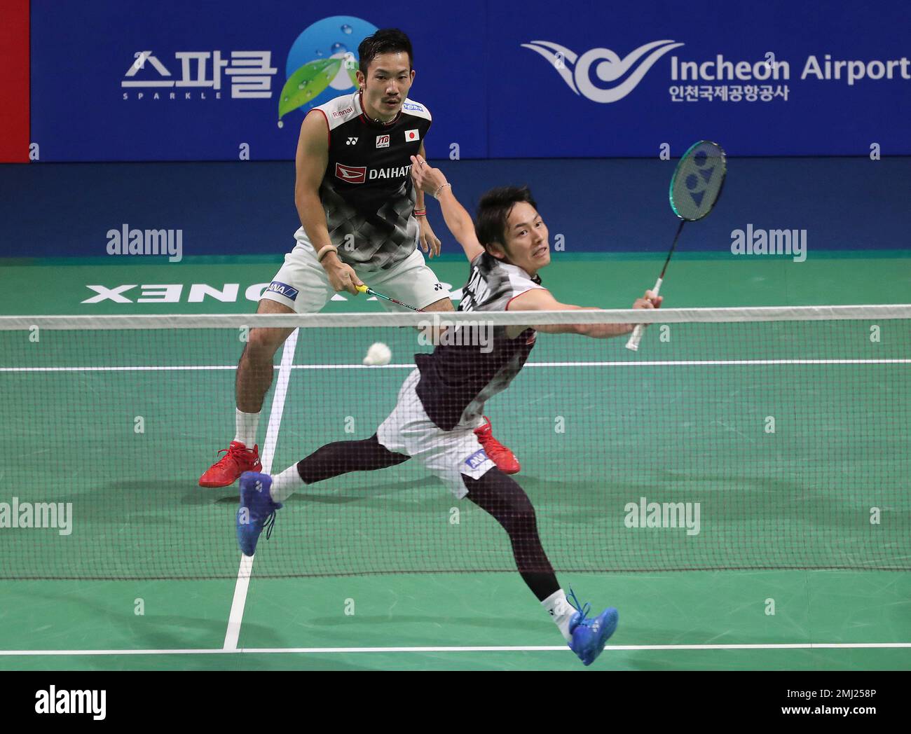 Japan's Takeshi Kamura, bottom, returns a shot as his teammate Keigo ...