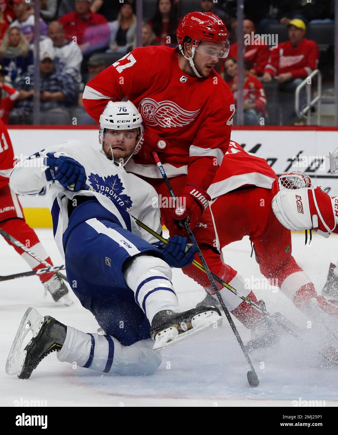 Toronto Maple Leafs center Hudson Elynuik (76) falls next to Detroit Red Wings center Michael ...
