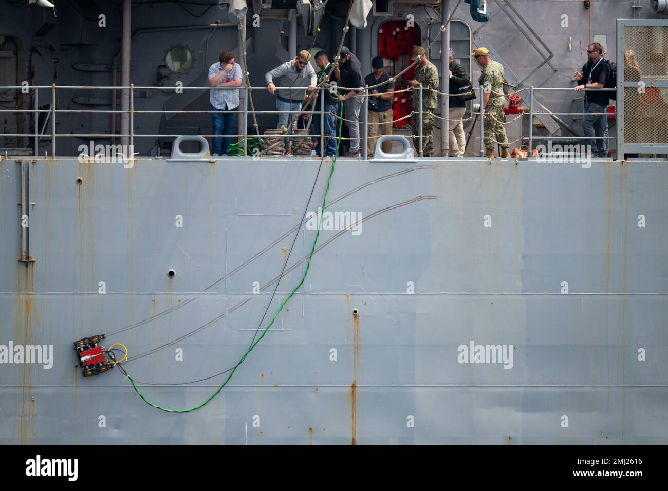 As observers and U.S. Navy Surge Maintenance (SurgeMain) sailors look ...