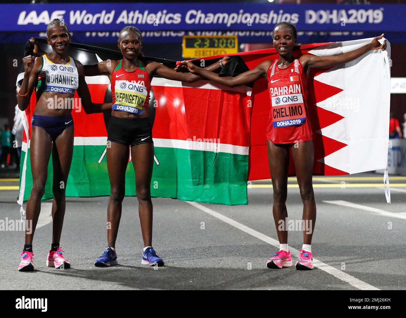 First place Ruth Chepngetich, of Kenya, center, celebrates with second ...