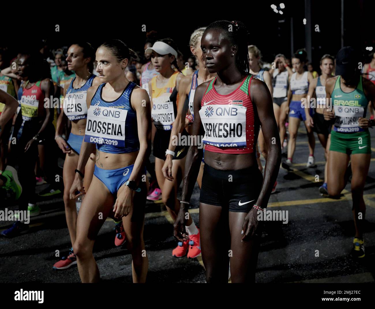 Athletes walk to the start line during the women's marathon at the ...