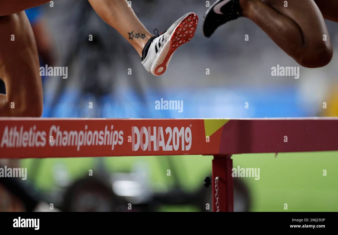 Athletes compete during the women's 3,000 meters steeple chase heat at ...