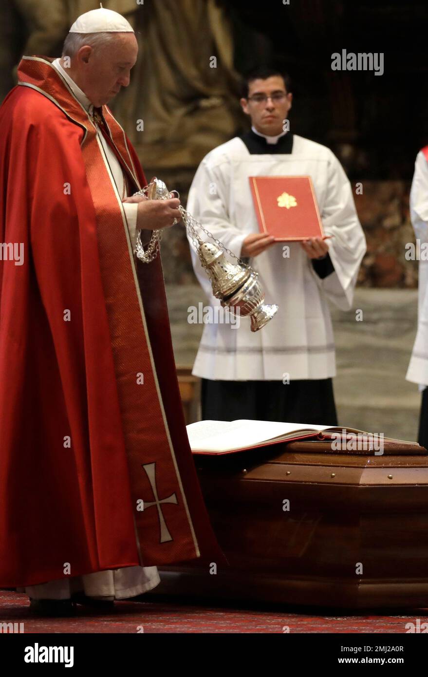 Pope Francis spreads incense on the coffin of Cardinal William Joseph ...