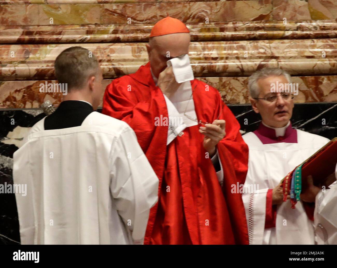 Cardinal Tarcisio Bertone wipes his eyes as he celebrates Mass at the ...