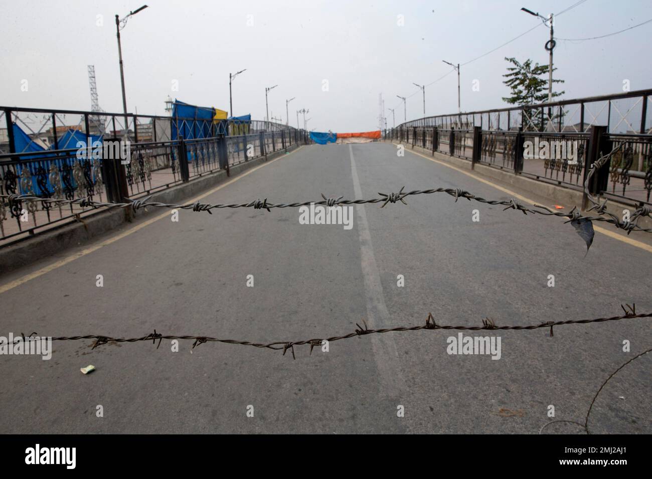 Barbed wire barricade set up by paramilitary force soldiers to close a ...