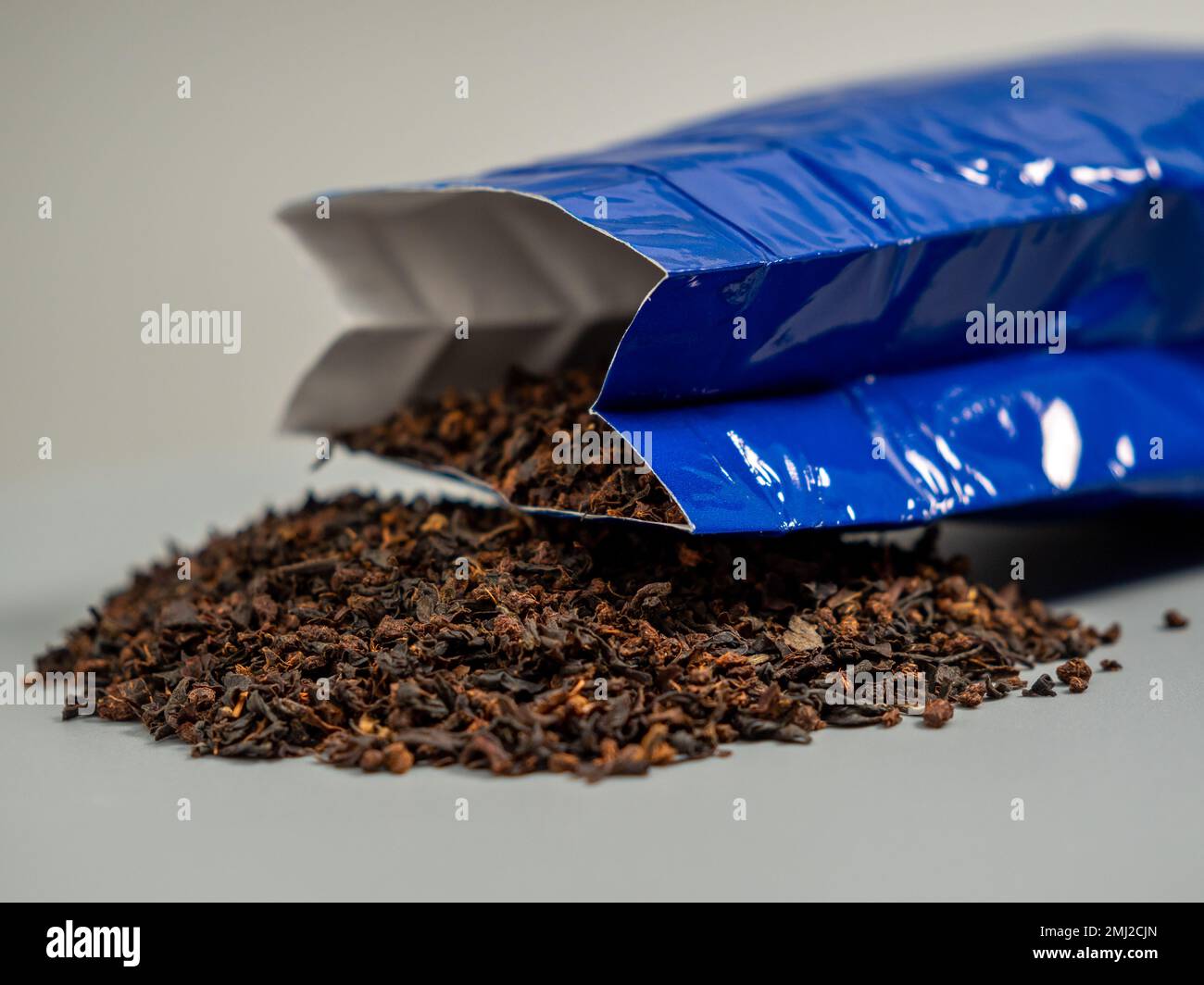 Black tea. Dry brewing of black tea. Black tea packaging Stock Photo ...