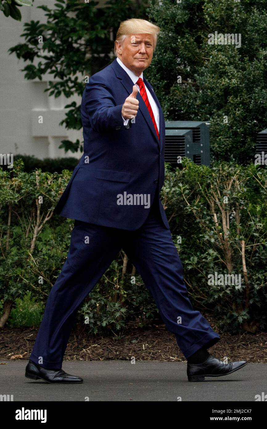 President Donald Trump gives the thumbs-up as he arrives for a ceremony ...