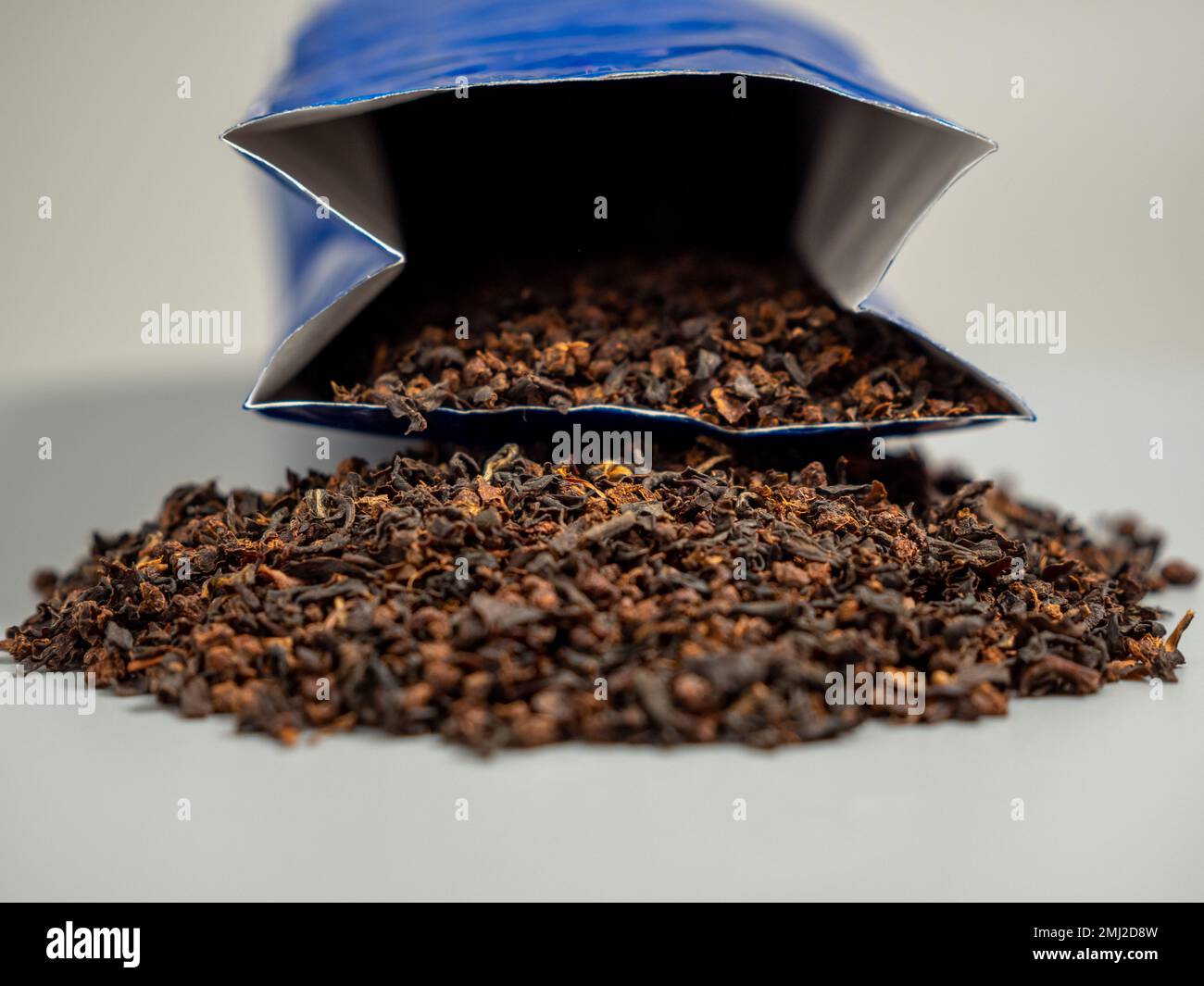 Black tea. Dry brewing of black tea. Black tea packaging Stock Photo ...
