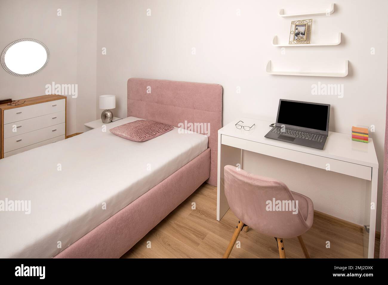 Pink girls student room with a bad and desk Stock Photo - Alamy