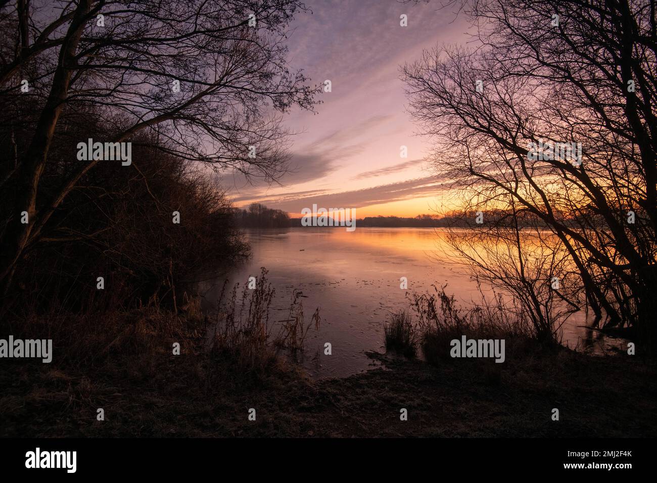 Sunrise reflections on a frozen lake at Colwick Park, Nottingham ...
