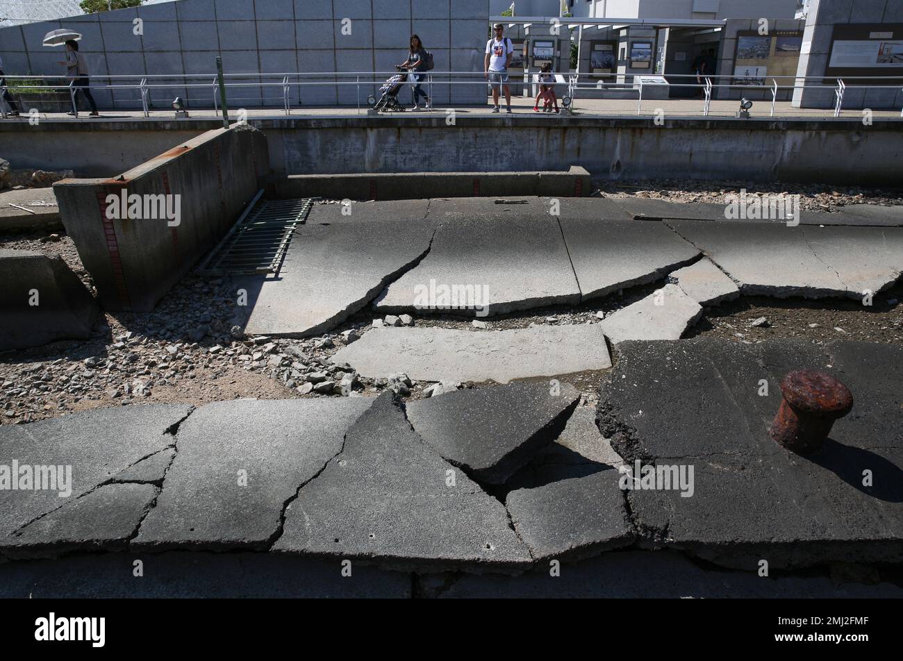 Tourists look at the Port of Kobe Earthquake Memorial Park in Kobe ...