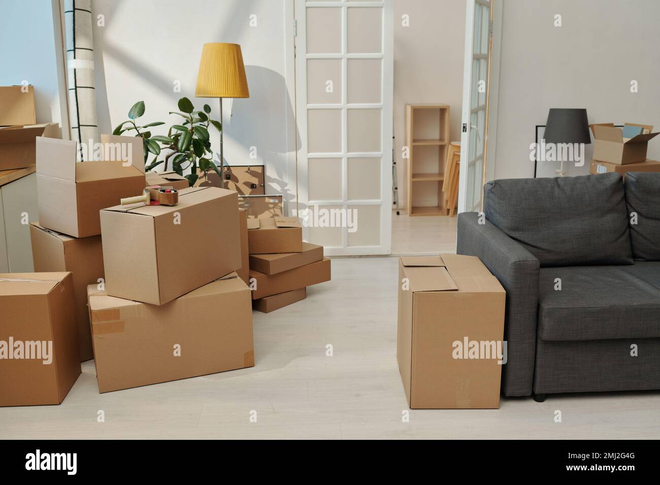Horizontal image of modern apartment with packed boxes for moving to a ...
