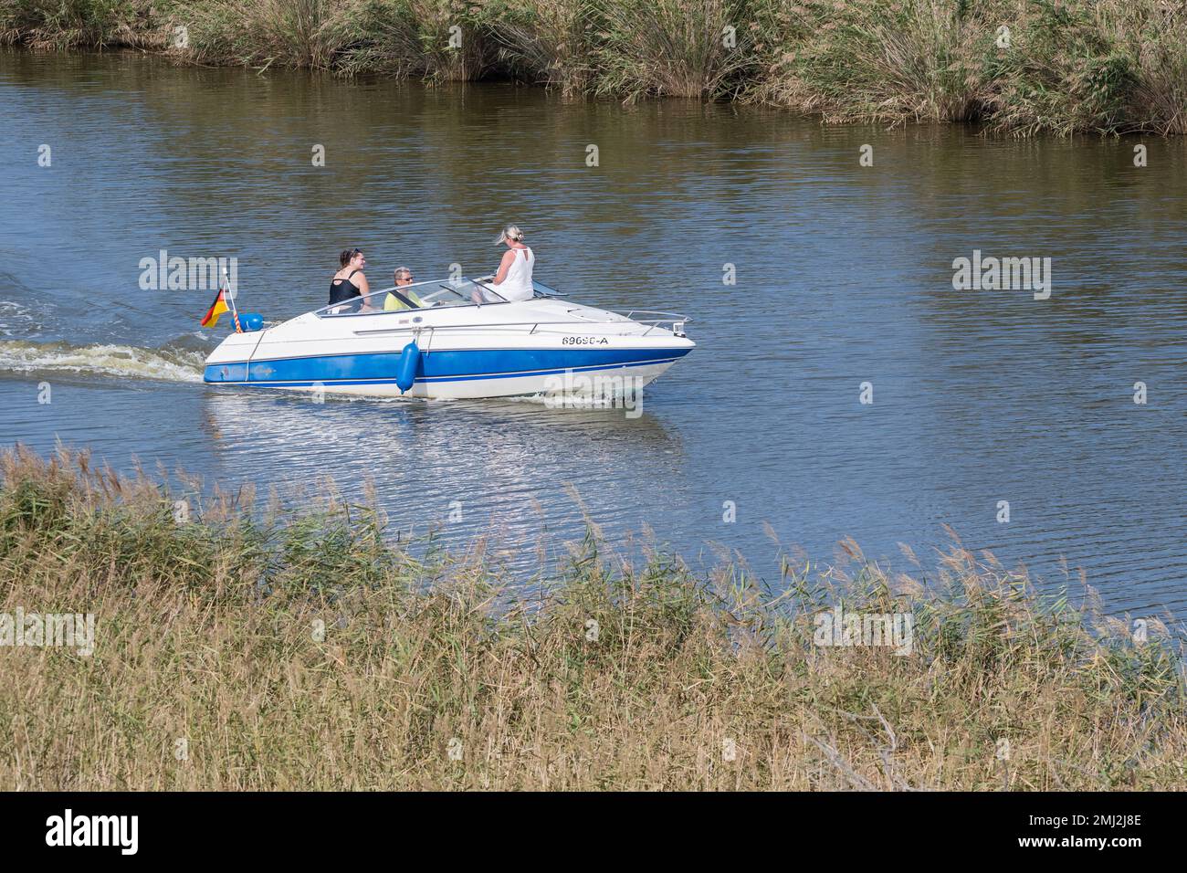 deck boat with family motoring sailing in the river Ebro, Ebro delta ...
