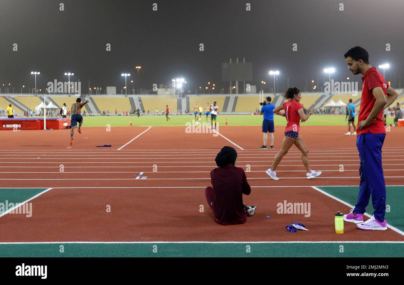 An athlete sits on the track at the training stadium prior the start of ...
