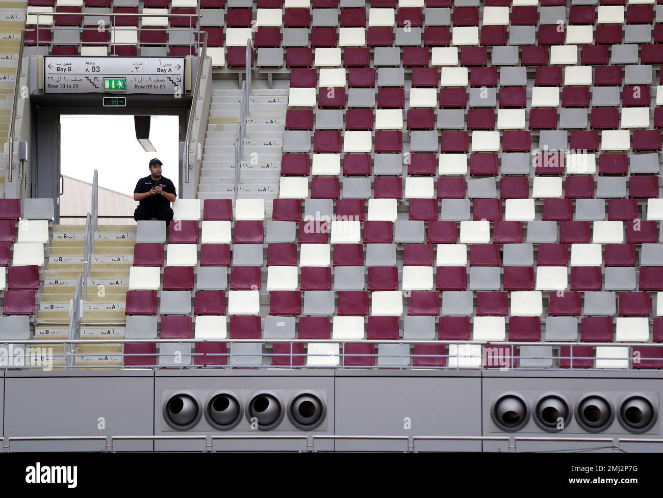 Security guard sits inside the Khalifa International Stadium prior the ...